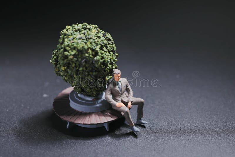 A Mini of Figure Sit on the Park Bench Stock Photo - Image of concept ...