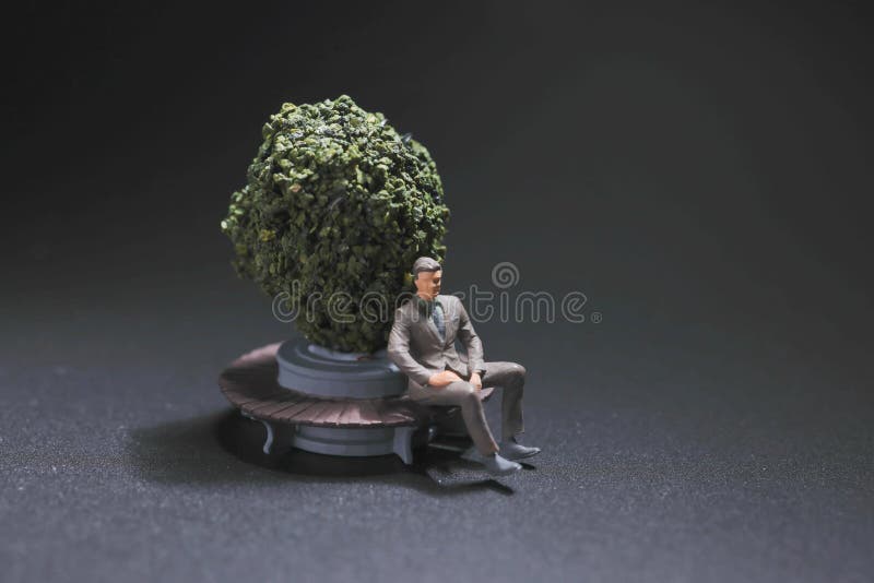 A Mini of Figure Sit on the Park Bench Stock Image - Image of laptop ...