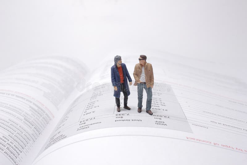 A Mini Figure Stand on the Open Book Stock Image - Image of indoors ...
