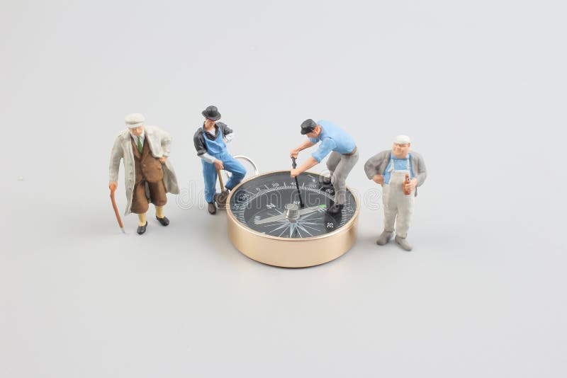 Mini Figure Standing on a Compass Stock Photo - Image of suit ...