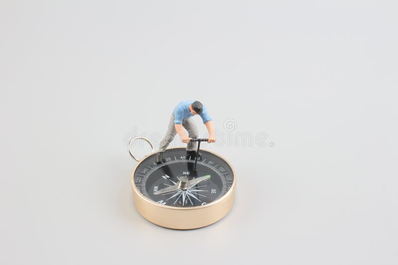 Mini Figure Standing on a Compass Stock Photo - Image of travelers ...