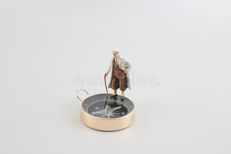 Mini Figure Standing on a Compass Stock Photo - Image of businessman ...
