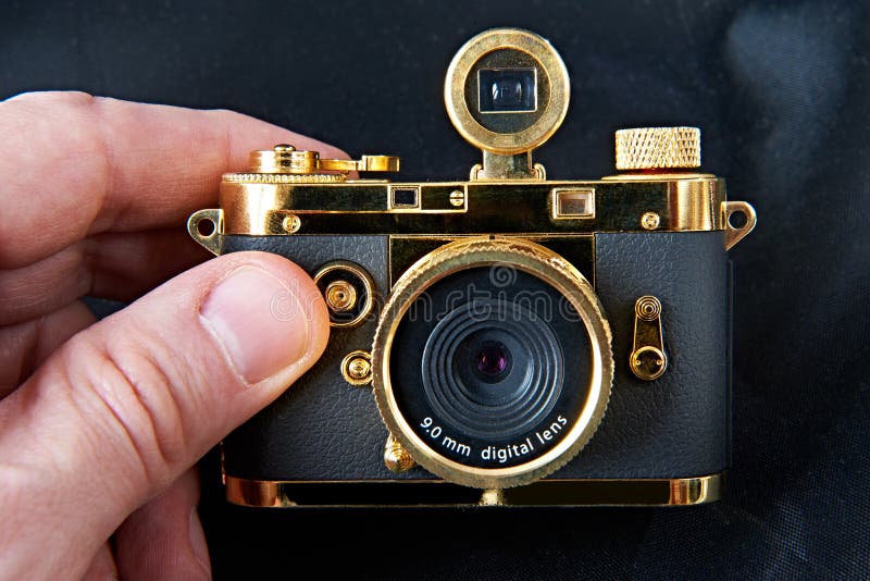 Mini Gift Golden Camera in Big Hand Stock Image - Image of black ...
