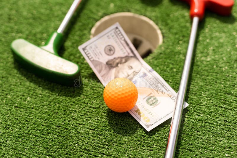 Mini Golf Club, Ball and Money on the Artificial Grass Stock Image ...