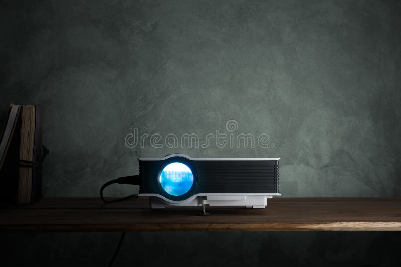 Mini Led Projector on Wood Table in a Room Projector Home Theater ...