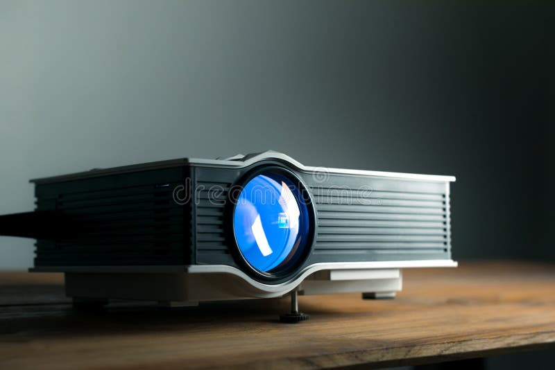 Mini Led Projector on Wood Table in a Room Projector Home Theater ...