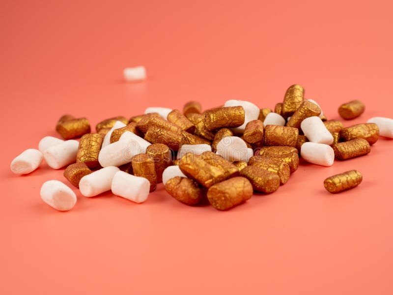 Mini Marshmallows on a Pink Background. Marshmallow Gold and White ...