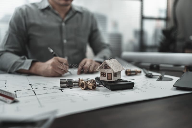 Mini Model House on Calculator and Them on Blueprint House Plan Design ...