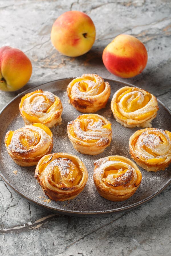 Mini Peach Rose Tarts with Puff Pastry Closeup on the Plate. Vertical ...
