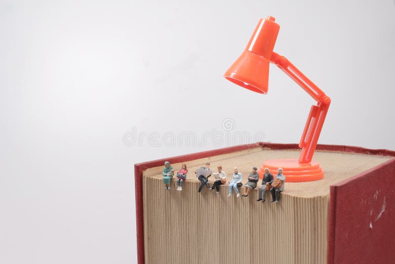 Mini People Sitting on Book with Lamp Using As Background Stock Image ...