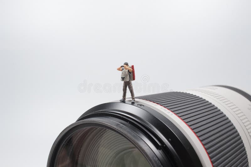 A Mini Photographer Standing on a Camera Lens Stock Photo - Image of ...