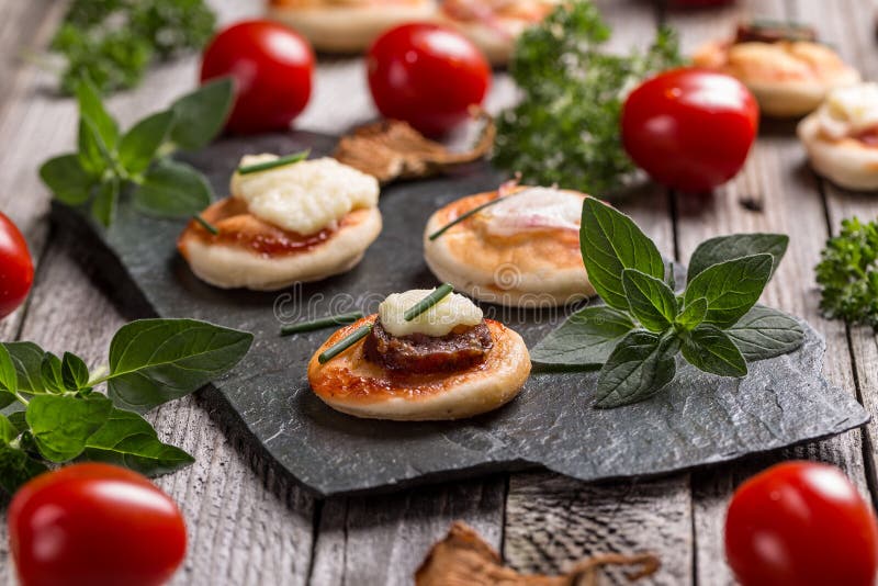 Mini Pizzas on Baking Tray stock photo. Image of pizzas - 138258340