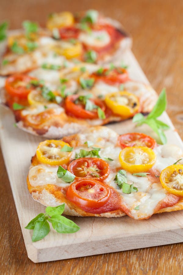 Mini Pizzas with Mozzarella and Cherry Tomatoes Stock Image - Image of ...