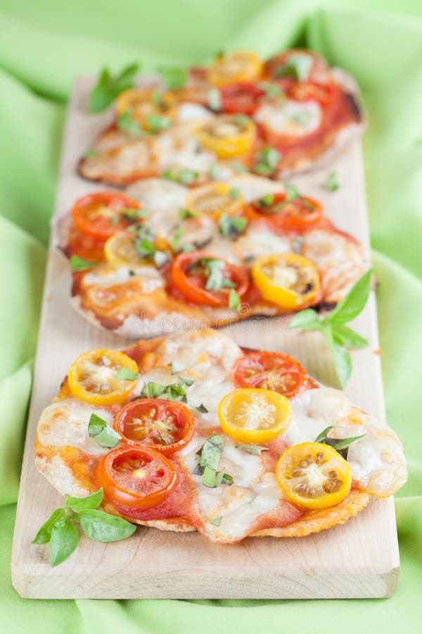 Mini Pizzas with Mozzarella and Cherry Tomatoes Stock Image - Image of ...