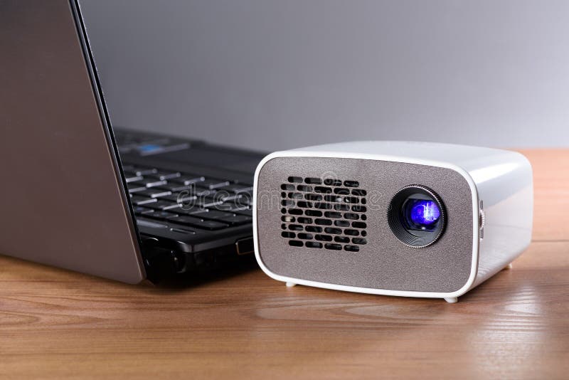 Mini Projector with Notebook on Wooden Table Stock Photo - Image of ...