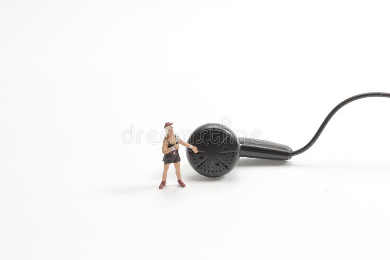 Mini Singer and Guitar Player Standing on a Pair of Ear Buds Stock ...