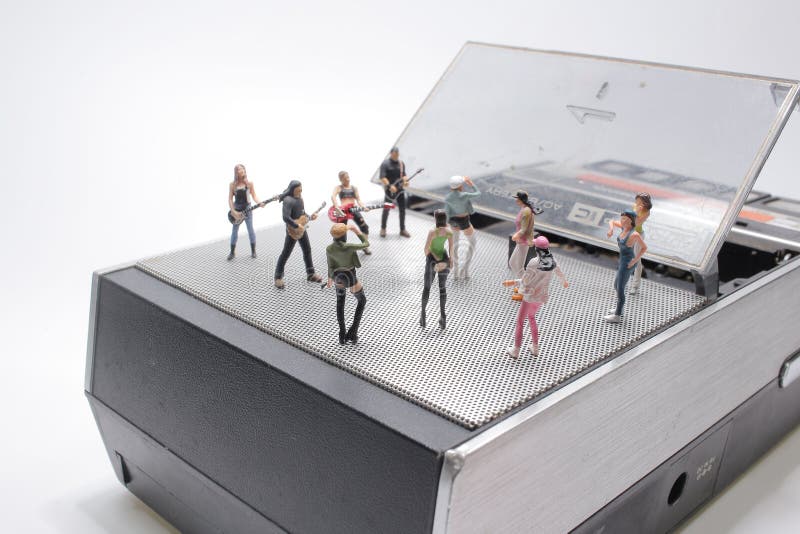 A Mini Singer and Guitar Player Standing on Speaker Stock Photo - Image ...