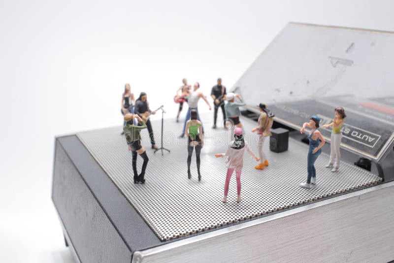 A Mini Singer and Guitar Player Standing on Speaker Stock Image - Image ...