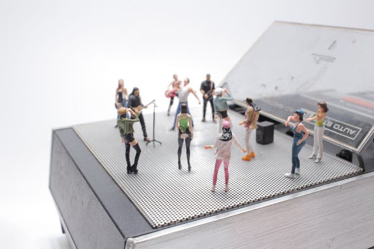 A Mini Singer and Guitar Player Standing on Speaker Stock Image - Image ...