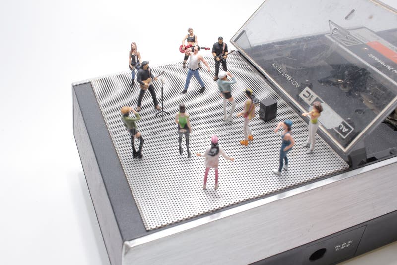 A Mini Singer and Guitar Player Standing on Speaker Stock Image - Image ...