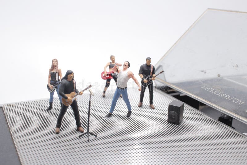 A Mini Singer and Guitar Player Standing on Speaker Stock Image - Image ...