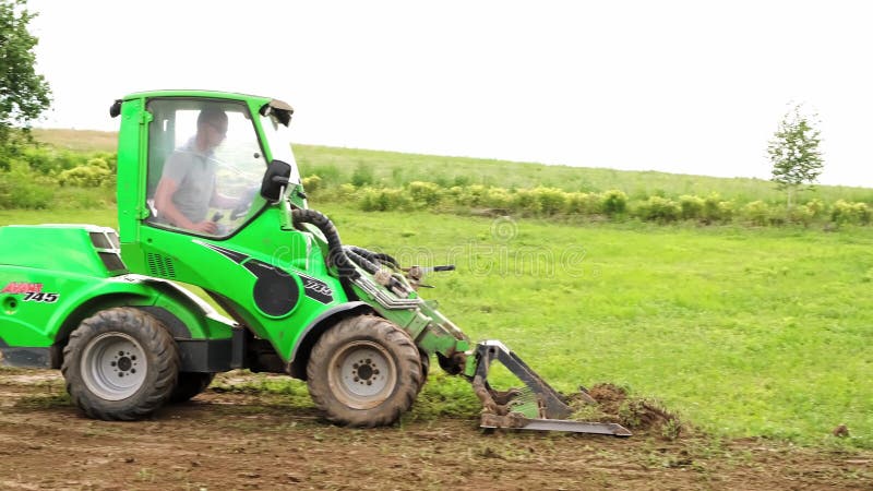 Mini Skid Steer Loader Clear the Construction Site. Land Work by the ...