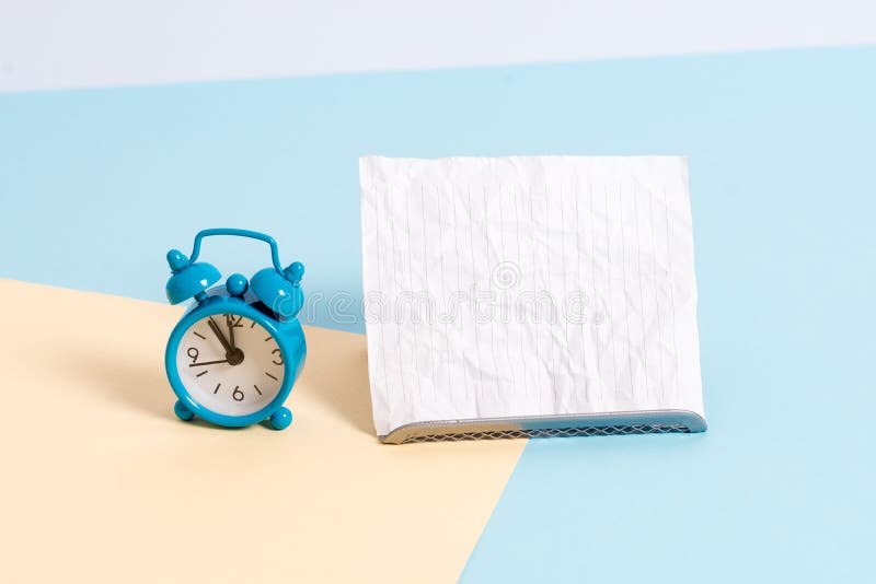 Mini Small Size Alarm Clock beside a Paper Sheet Placed Tilted ...