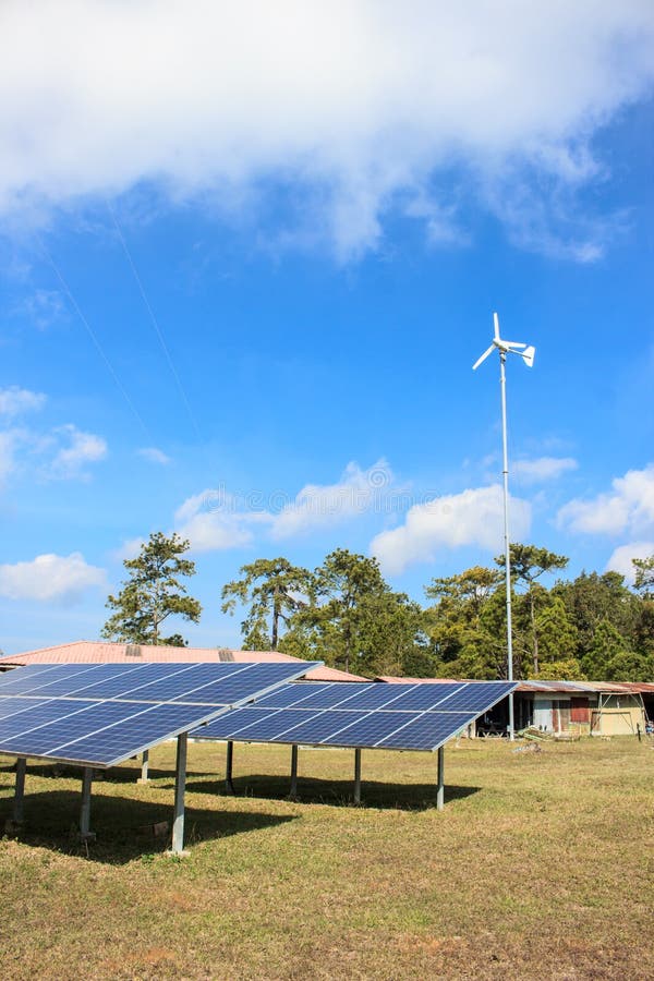 Mini Solar Farm and White Windmill in Fresh Day Stock Photo - Image of ...