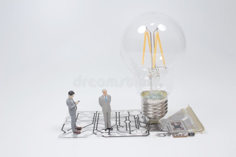 A Mini Technician with the Blub and Integrated Circuits Stock Photo ...