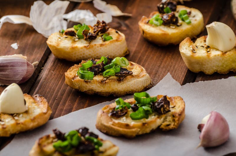 Mini Toasts with Garlic and Dried Tomato Stock Photo - Image of italian ...