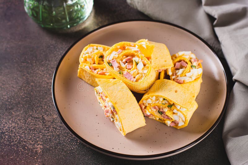 Mini Tortilla Rolls with Chopped Sausages, Cheese, Eggs and Herbs on a ...