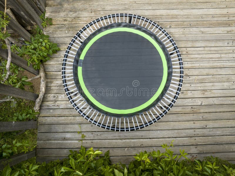 Mini Trampoline for Rebounding Workout on a Wooden Backyard Deck Stock ...