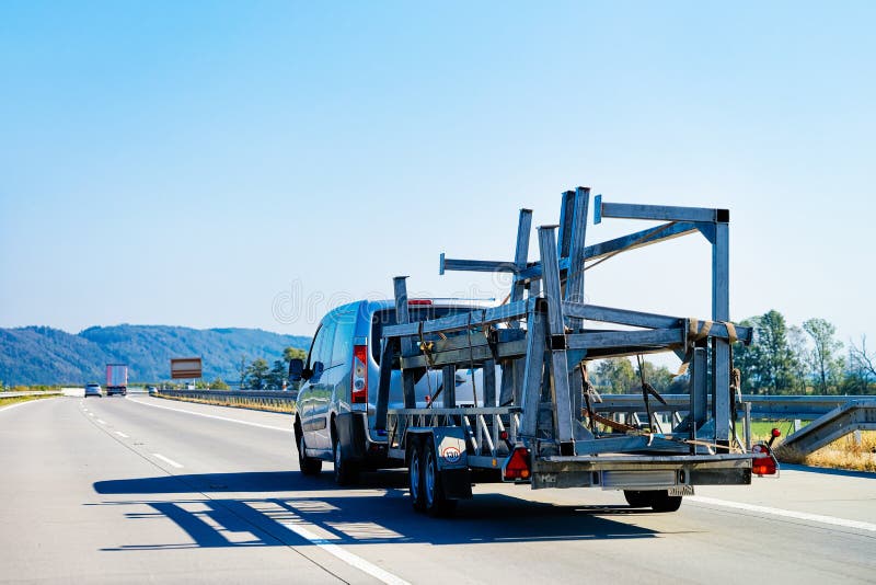 Mini Van Carrying Trailer on Asphalt Road in Slovenia Stock Photo ...