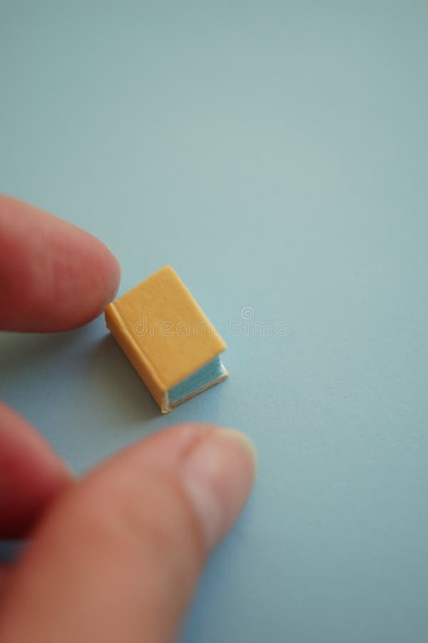 Miniature Book and Female Fingers, Mini Book Notepad Craft on Th Stock ...