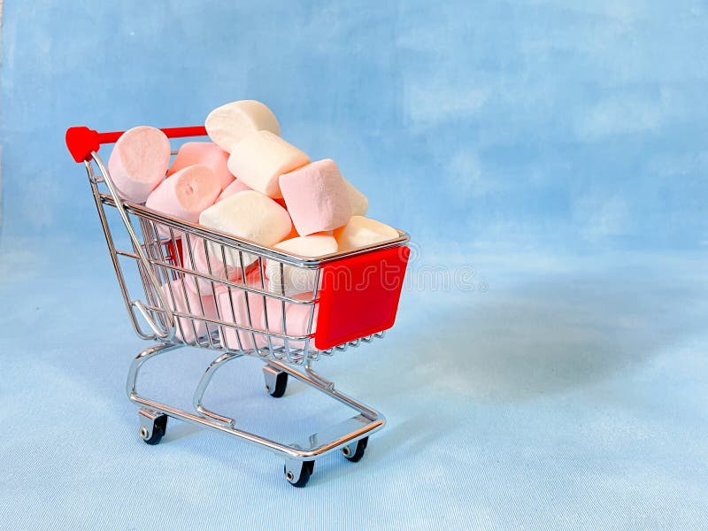 Miniature Cart from a Supermarket with Marshmallows. Blue Background ...