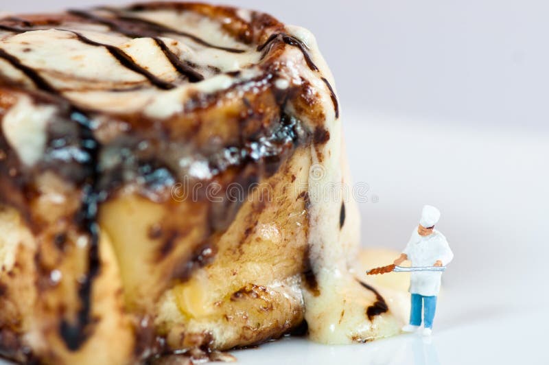 Miniature Chef with the Giant Cinnamon Roll Stock Photo - Image of mini ...