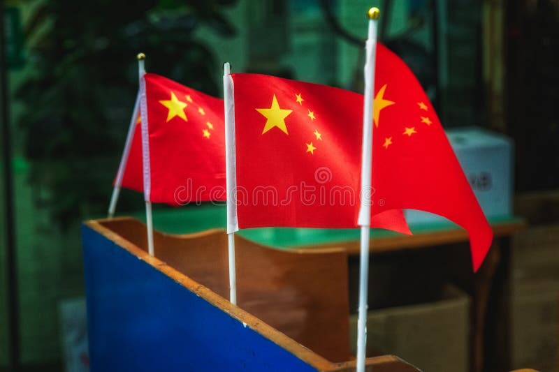 Miniature Chinese Flags on Desk Stock Photo - Image of orange ...