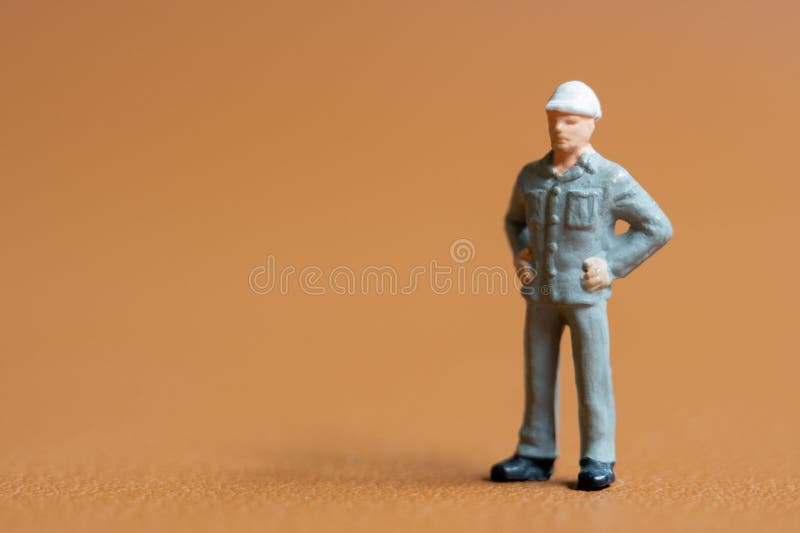 Miniature Construction Worker. a Man Dressed in a Blue Work Uniform ...