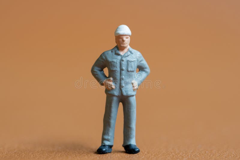 Miniature Construction Worker. a Man Dressed in a Blue Work Uniform ...