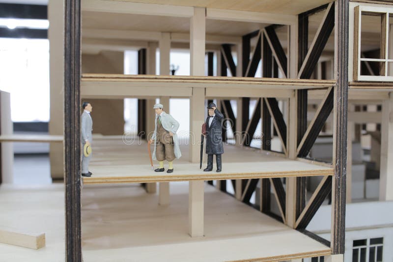 The Miniature Construction Workers Building Plans Stock Image - Image ...