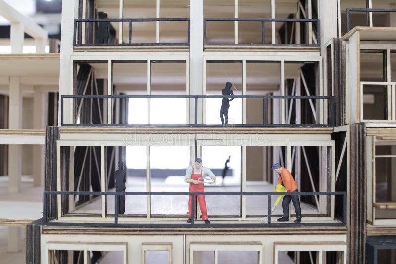 The Miniature Construction Workers Building Plans Stock Image - Image ...