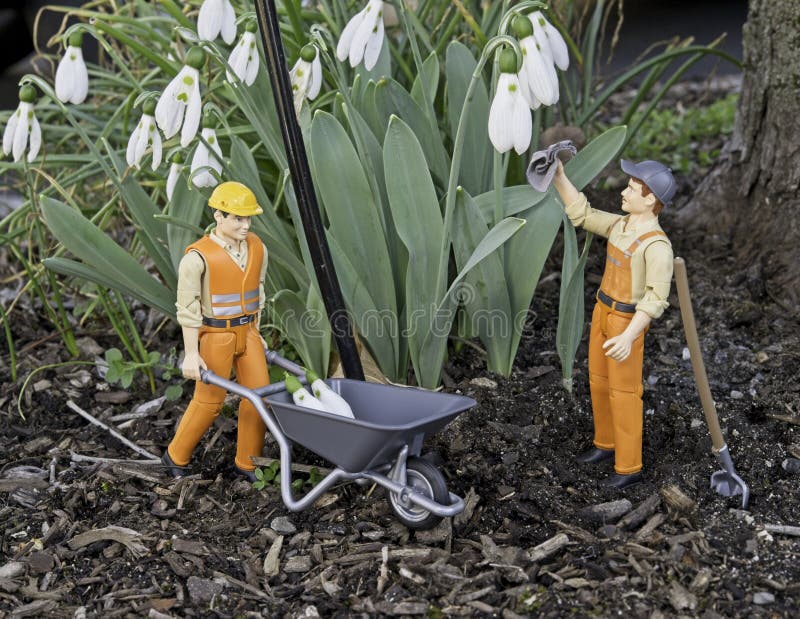 Miniature Construction Workers Working on Flowers in Yard 2 Stock Photo ...