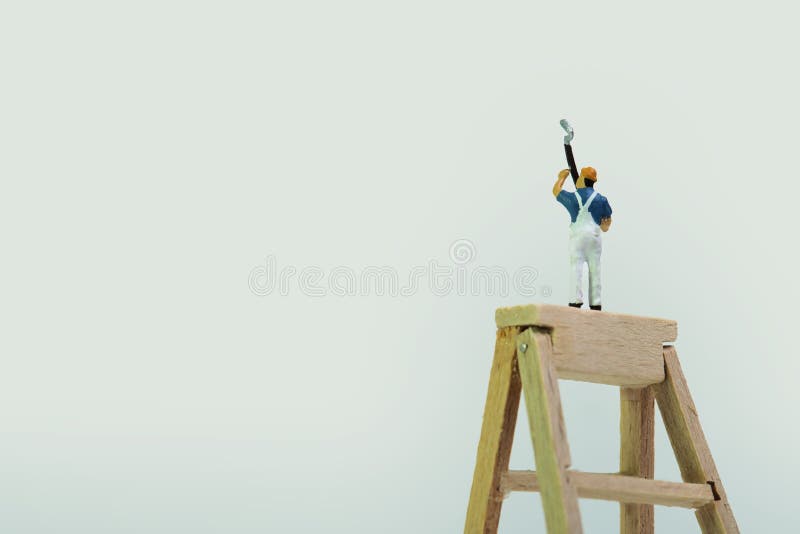 Miniature Figure of a Construction Worker Painting the Walls on a White ...