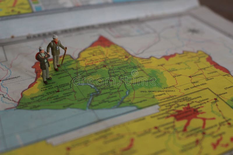 Miniature Figure of an Explorer Posing on a Map or Atlas Stock Image ...