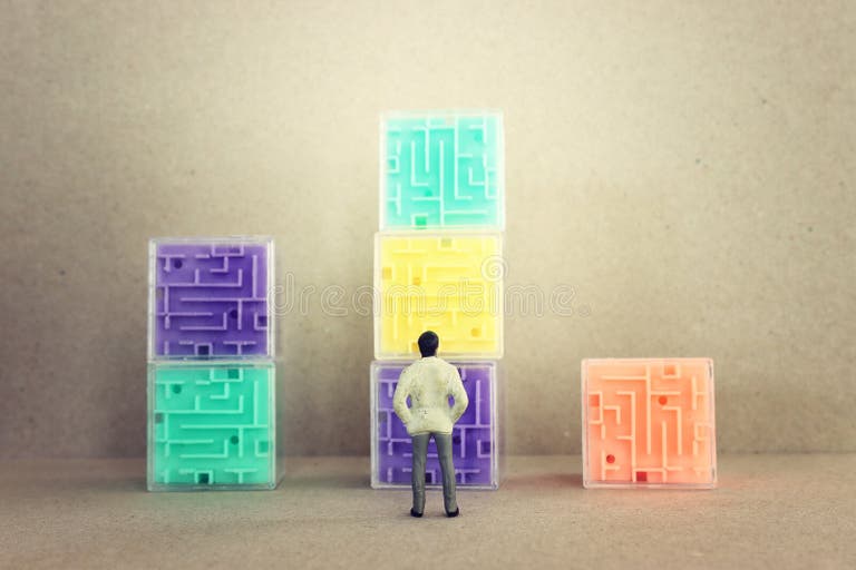 Miniature Figure of Man Looking at Cubes with Maze Pattern. Concept of ...