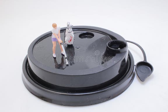 Miniature Figure Performing Maintenance on a Plastic Cup Lid Surface ...
