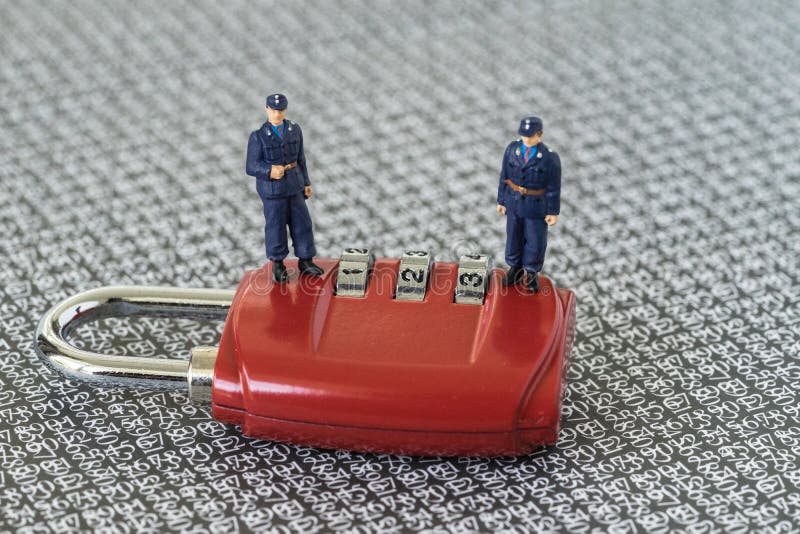 Miniature Figure Security Guards Standing on Red Combination Pad Stock ...