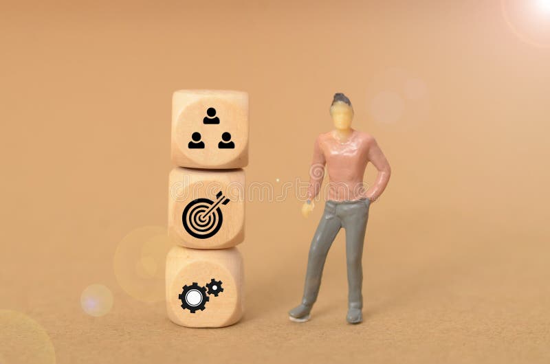 The Miniature Figure Standing Next To a Stack of Wooden Blocks with ...