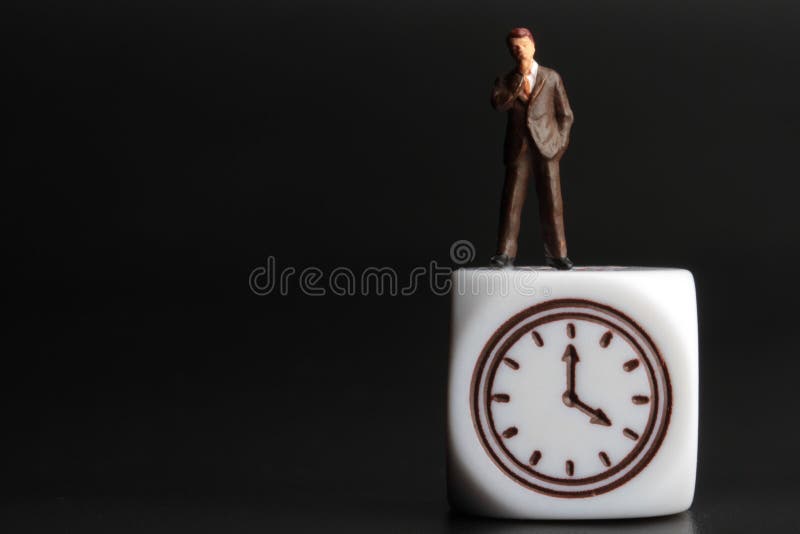 Miniature Figurine of a Businessman Standing on a Clock Sign Stock ...