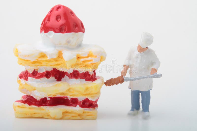 Miniature Figurine of a Cook with a Giant Slice of Cake Stock Photo ...